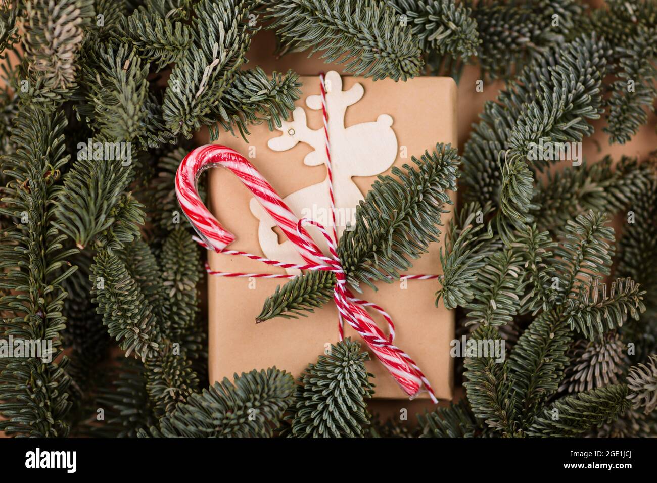 Christmas composition. gift box wrapped in craft paper, fir tree ...