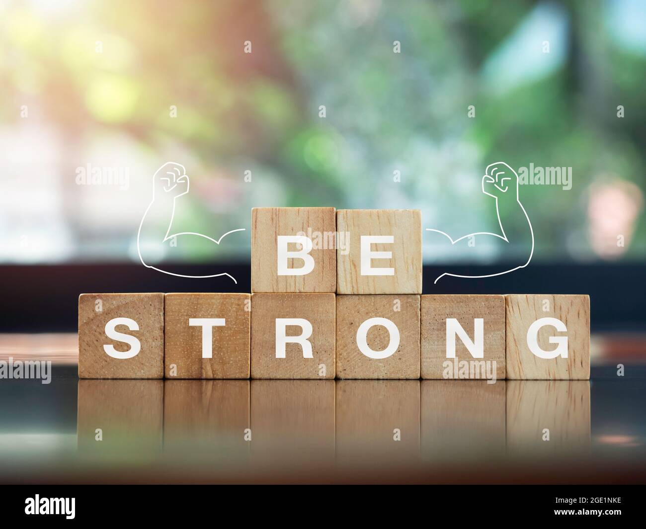 Be strong concept. Word "BE STRONG" on wooden blocks with muscle arms ...