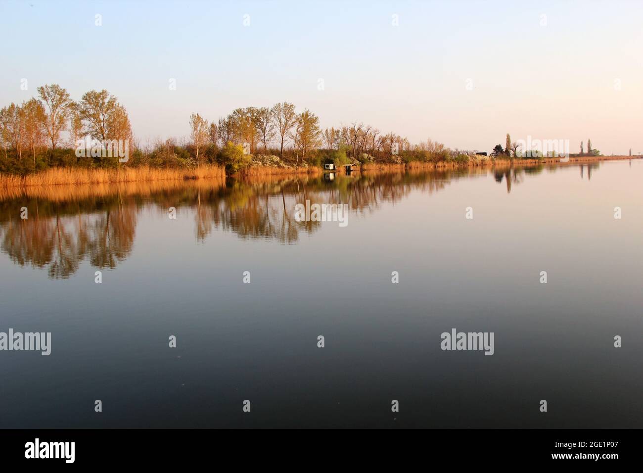 Lake House in Autumn Reflecting in Tranquil River Stock Photo - Alamy
