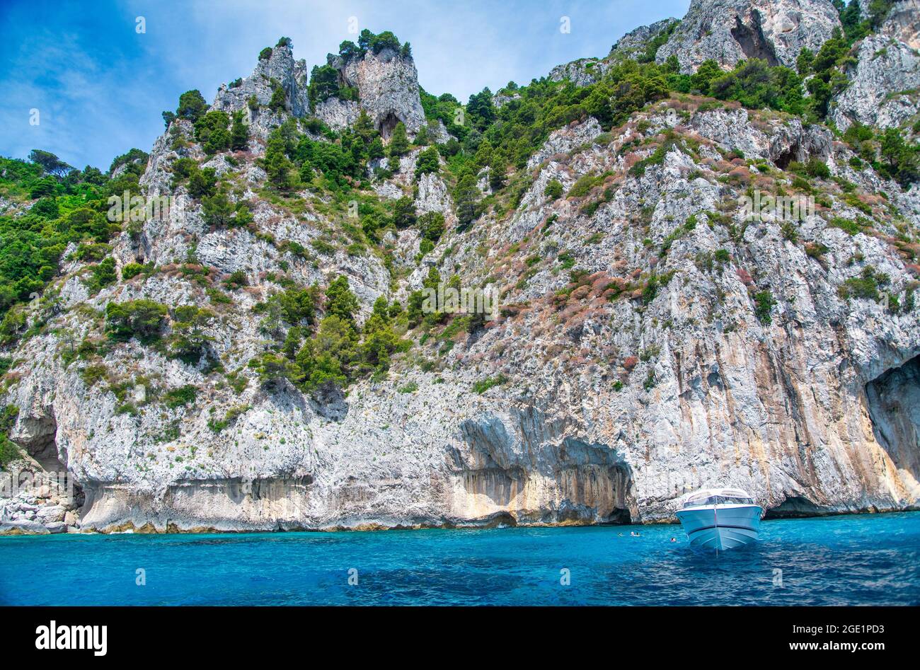 Beautiful coastal cliff with anchoredboat on water Stock Photo - Alamy