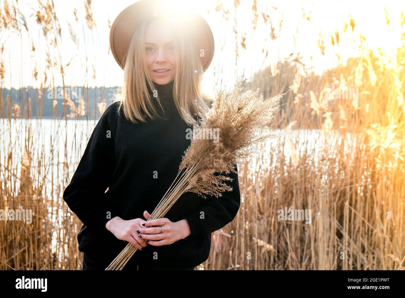 European blonde woman with beige hat in black sweater in the ...