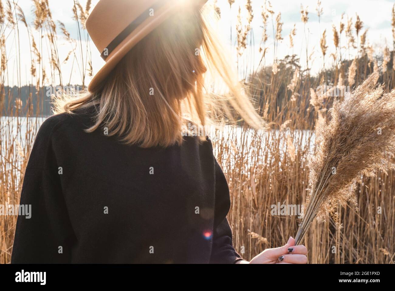 European blonde woman with beige hat in black sweater in the ...
