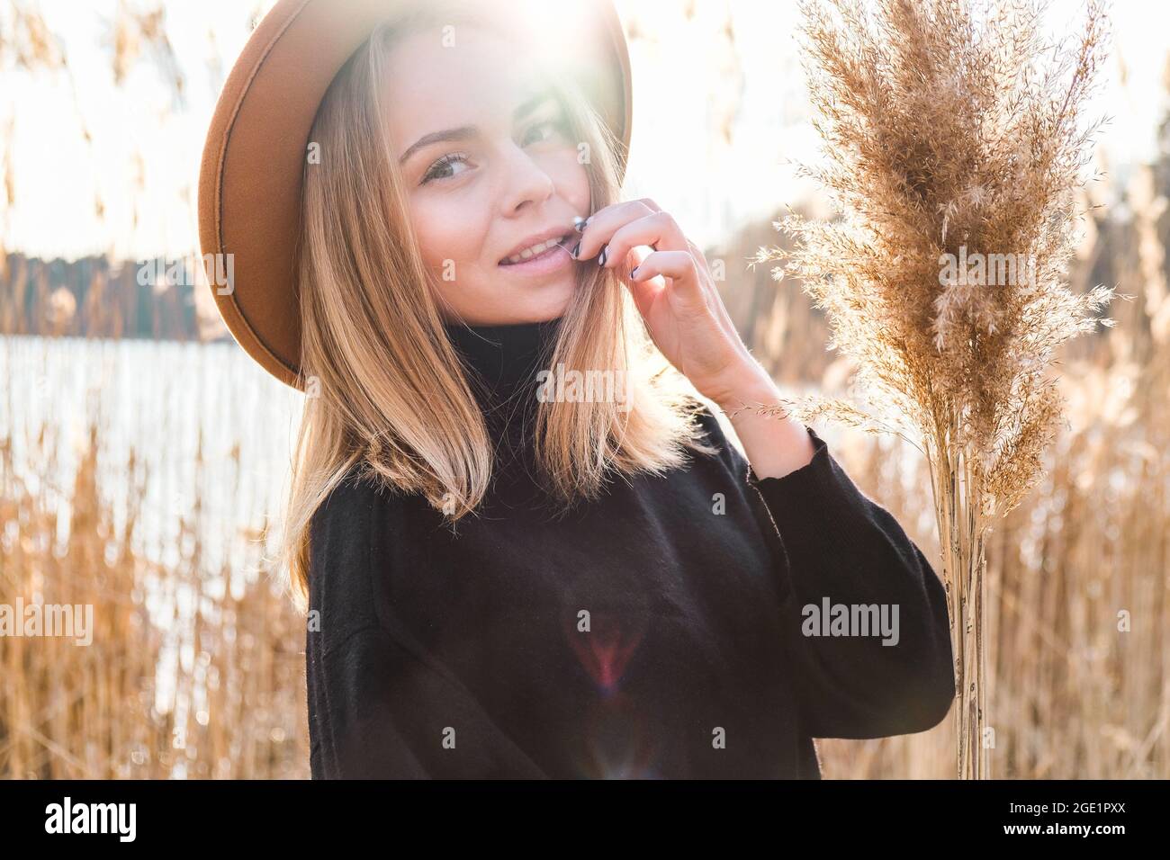 European blonde woman with beige hat in black sweater in the ...