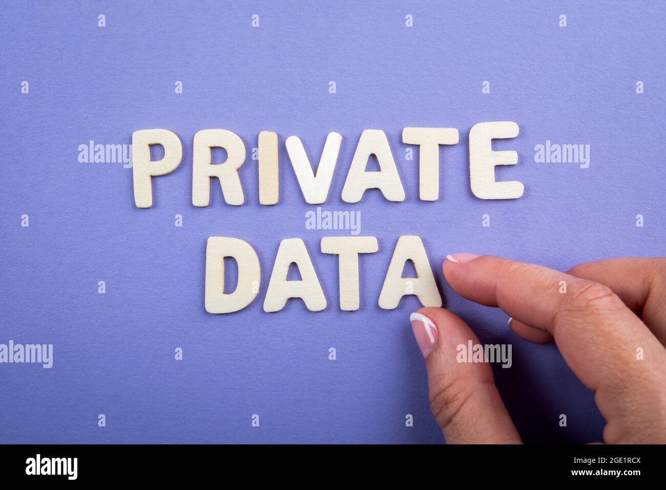 Private Data. White wooden letters with text on a purple background ...