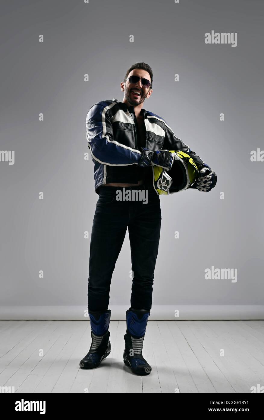 Happy unshaved adult man biker motocross racer in motorcycle leather ...