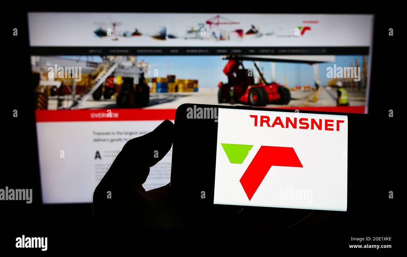 Person holding smartphone with logo of South African logistics company Transnet SOC Ltd. on ...