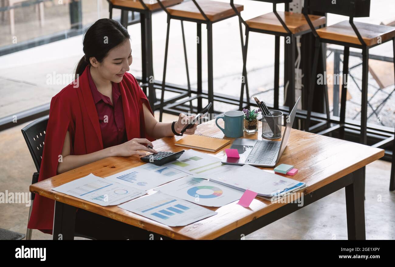 Business woman accountant analyze business report graph and finance ...