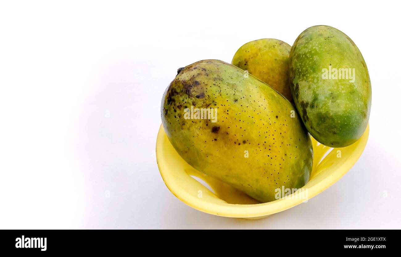 Three large ripe mangoes in a basket isolated on white background Stock ...