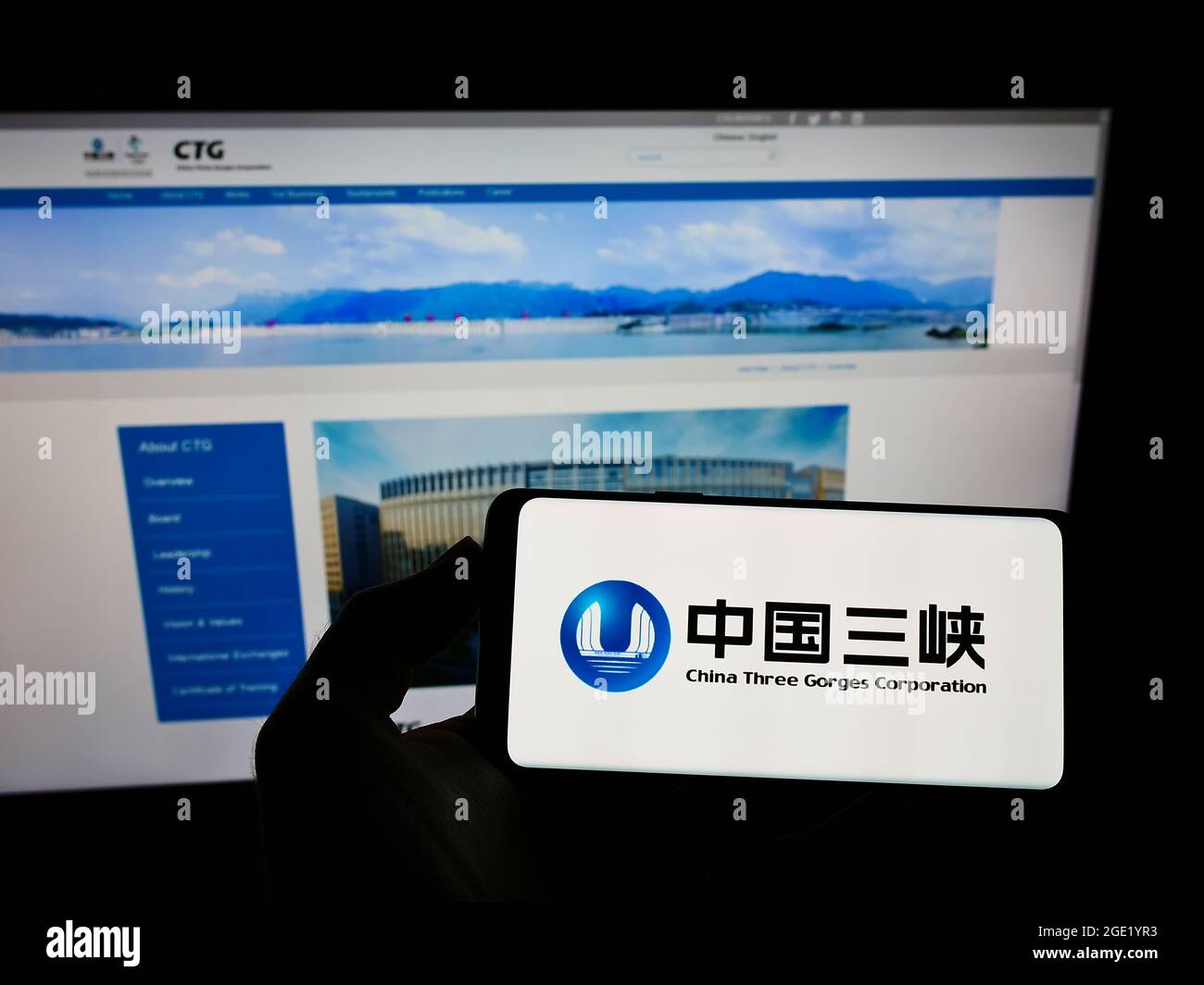 Person holding smartphone with logo of power company China Three Gorges ...