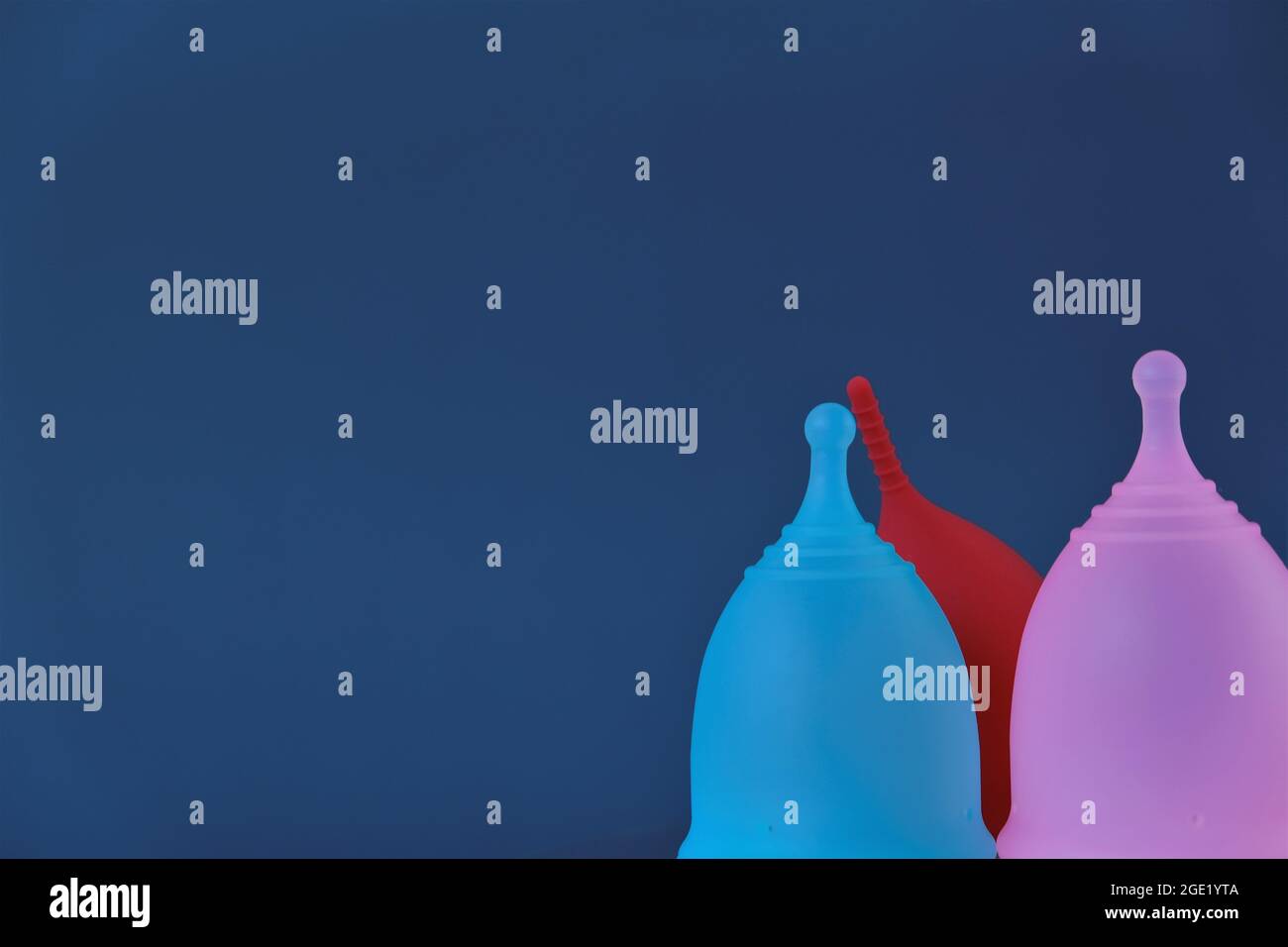 Menstrual cups.Menstrual period.menstrual silicone cups set on blue ...