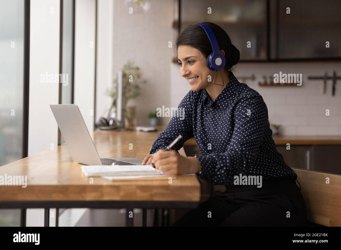 Indian woman learn english listen audio course through headphones Stock ...