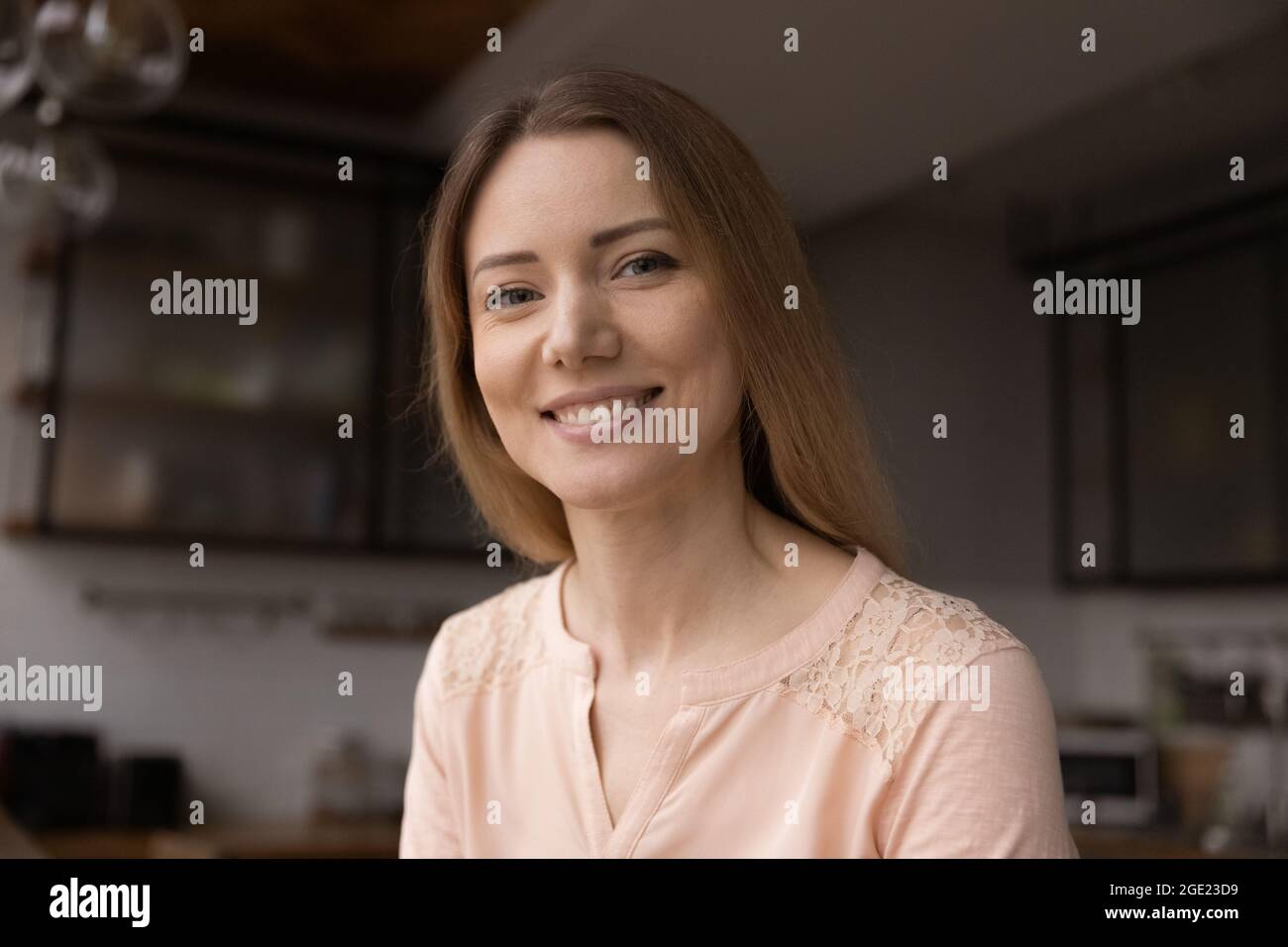 Headshot portrait young woman smile looks at camera Stock Photo - Alamy
