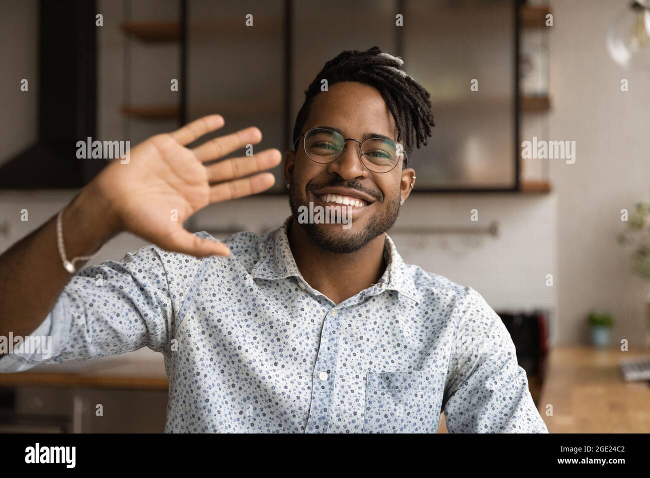 Handsome African guy wave hand greeting friend starting ...