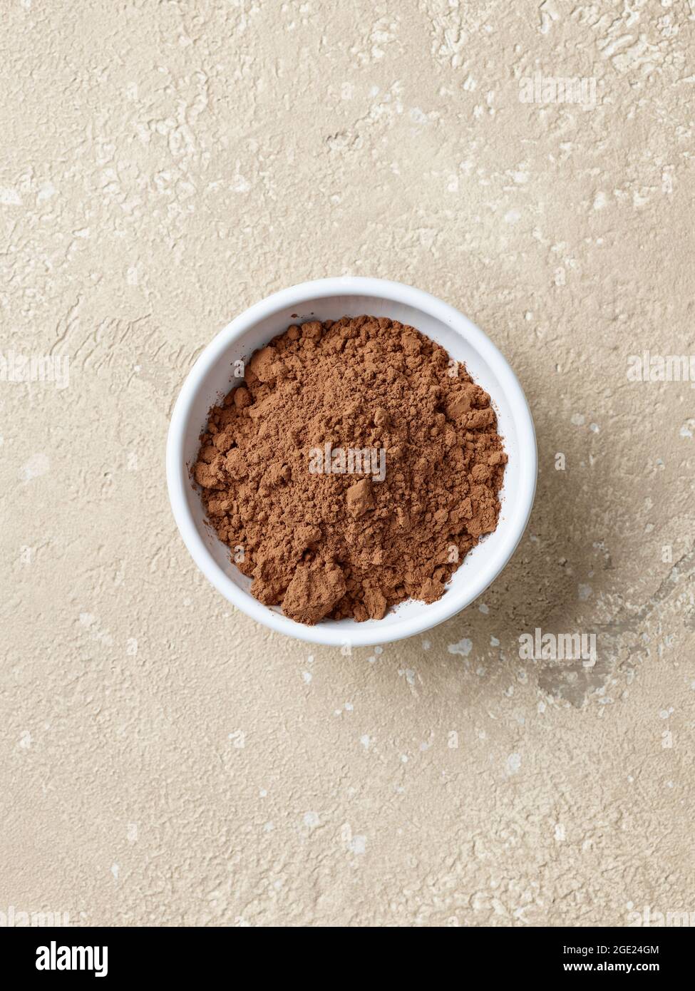 bowl of cocoa powder on beige color table background, top view Stock ...