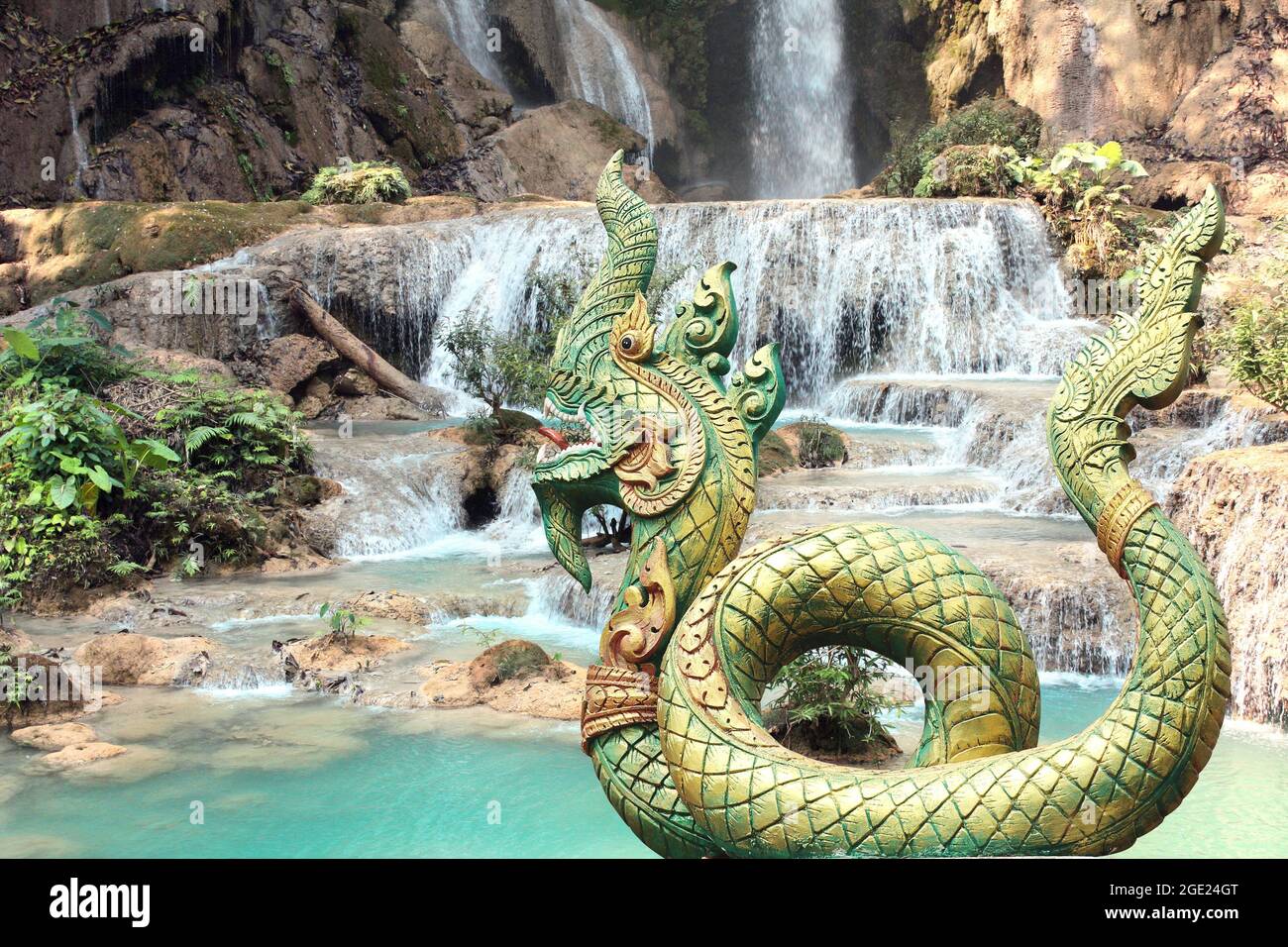 Ancient statue of mythical asian naga snake and Tad Kuang Si waterfall ...