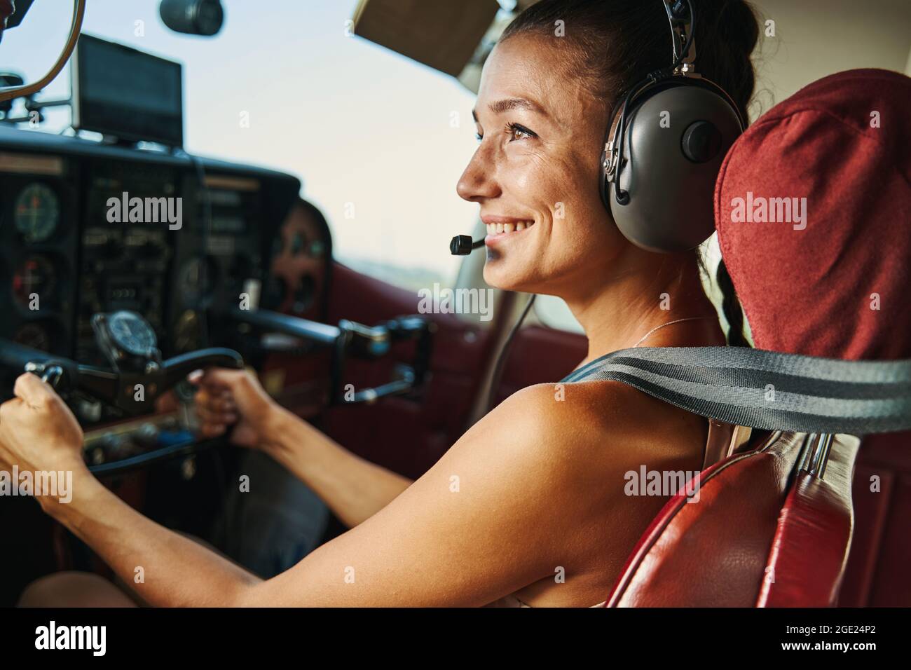 Positive delighted female person flying the plane Stock Photo - Alamy