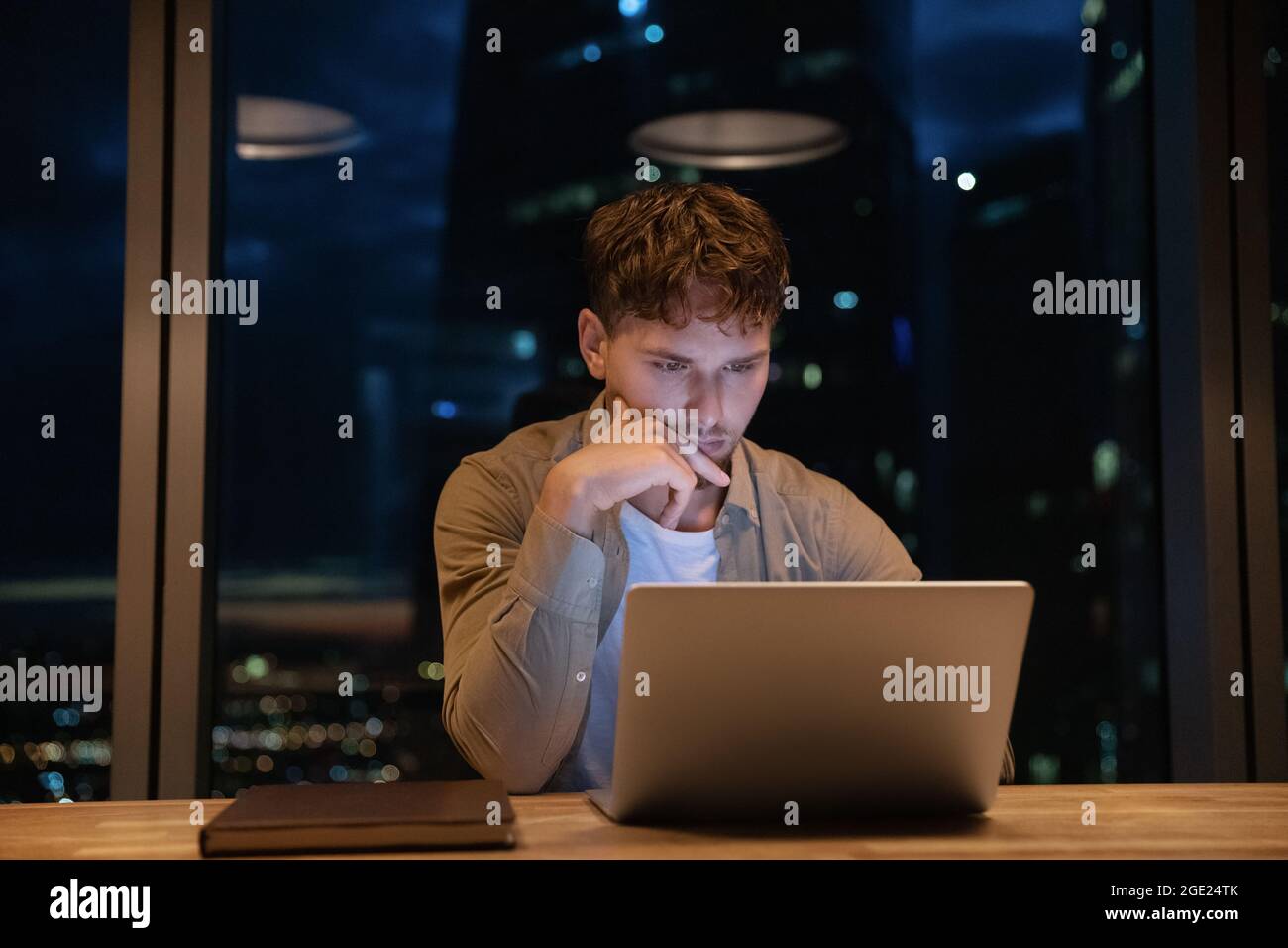 Employee working on laptop solve business until late in office Stock ...