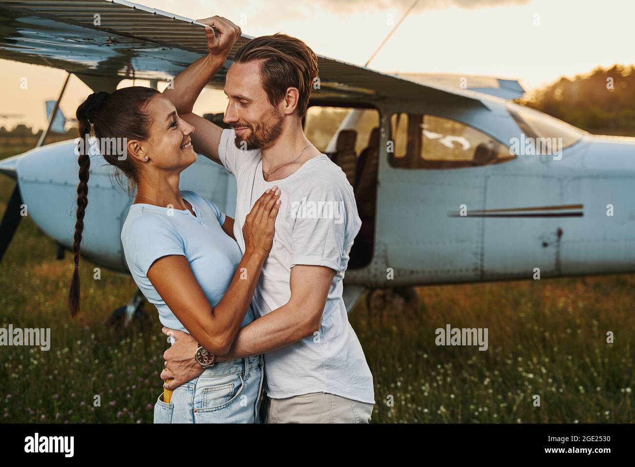 Young brunette woman being in arms of her man Stock Photo - Alamy