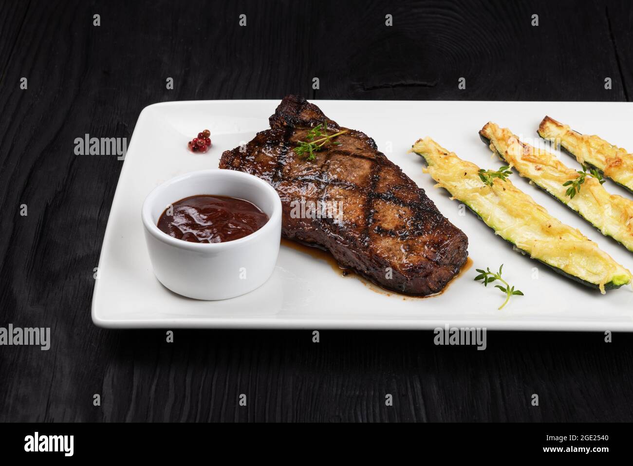 Grilled black angus strip loin steak New York with zucchini on white ...