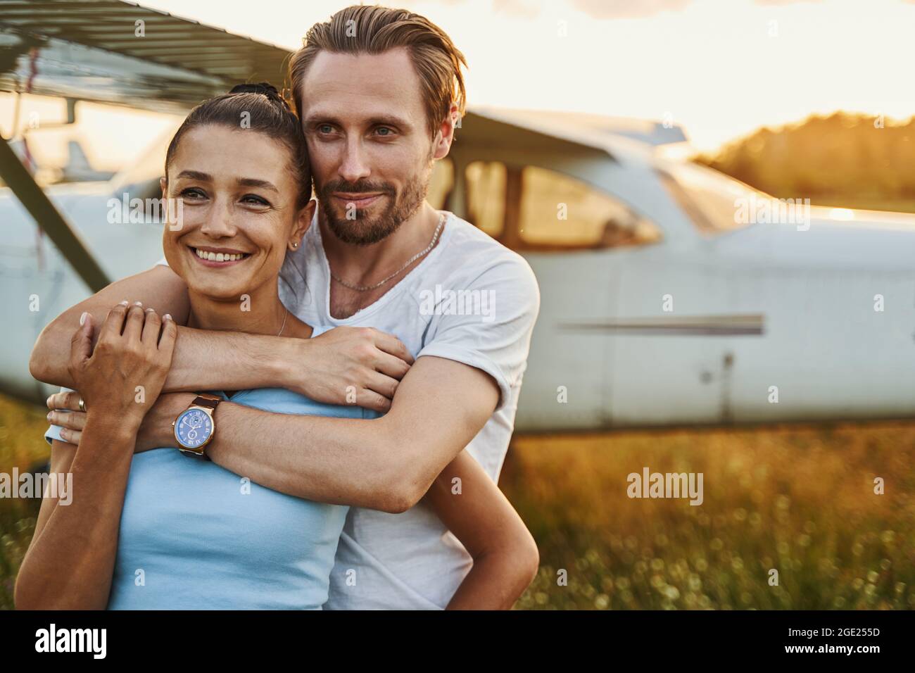 Amazing female person enjoying sunset on the field Stock Photo - Alamy