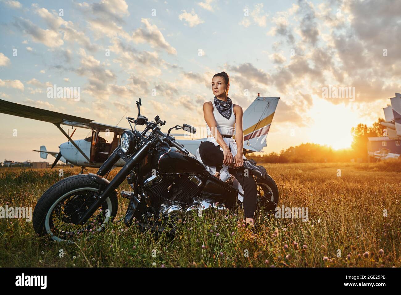 Stylish female person sitting on two-wheeled transport Stock Photo - Alamy
