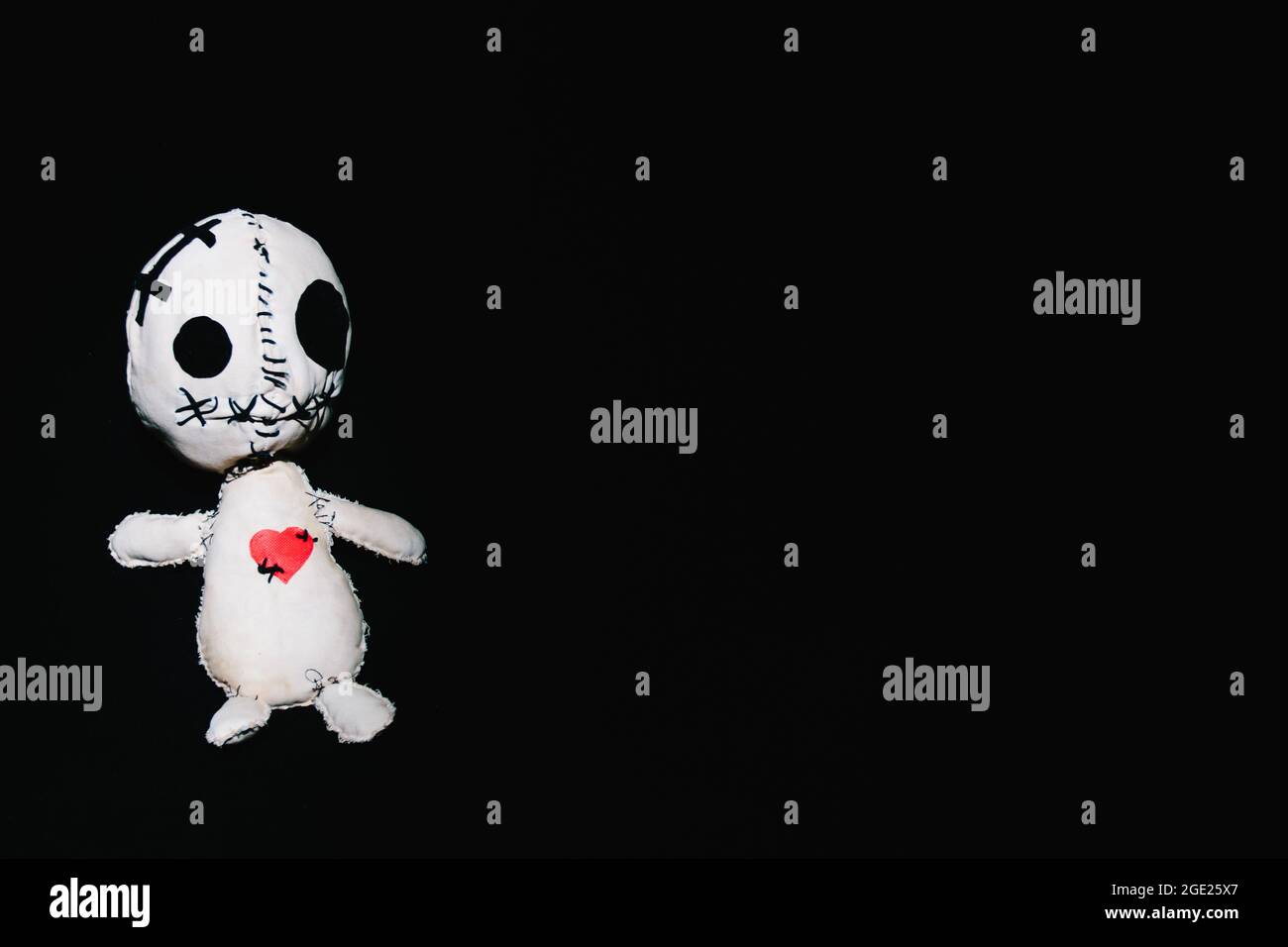 Voodoo magic ritual doll laying on a black background Stock Photo - Alamy