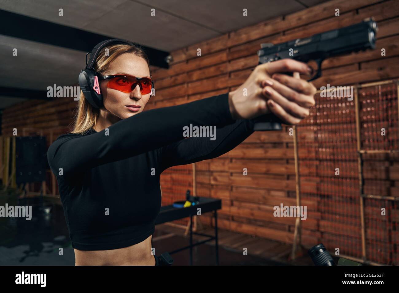 Focused pretty lady aiming at a target Stock Photo - Alamy
