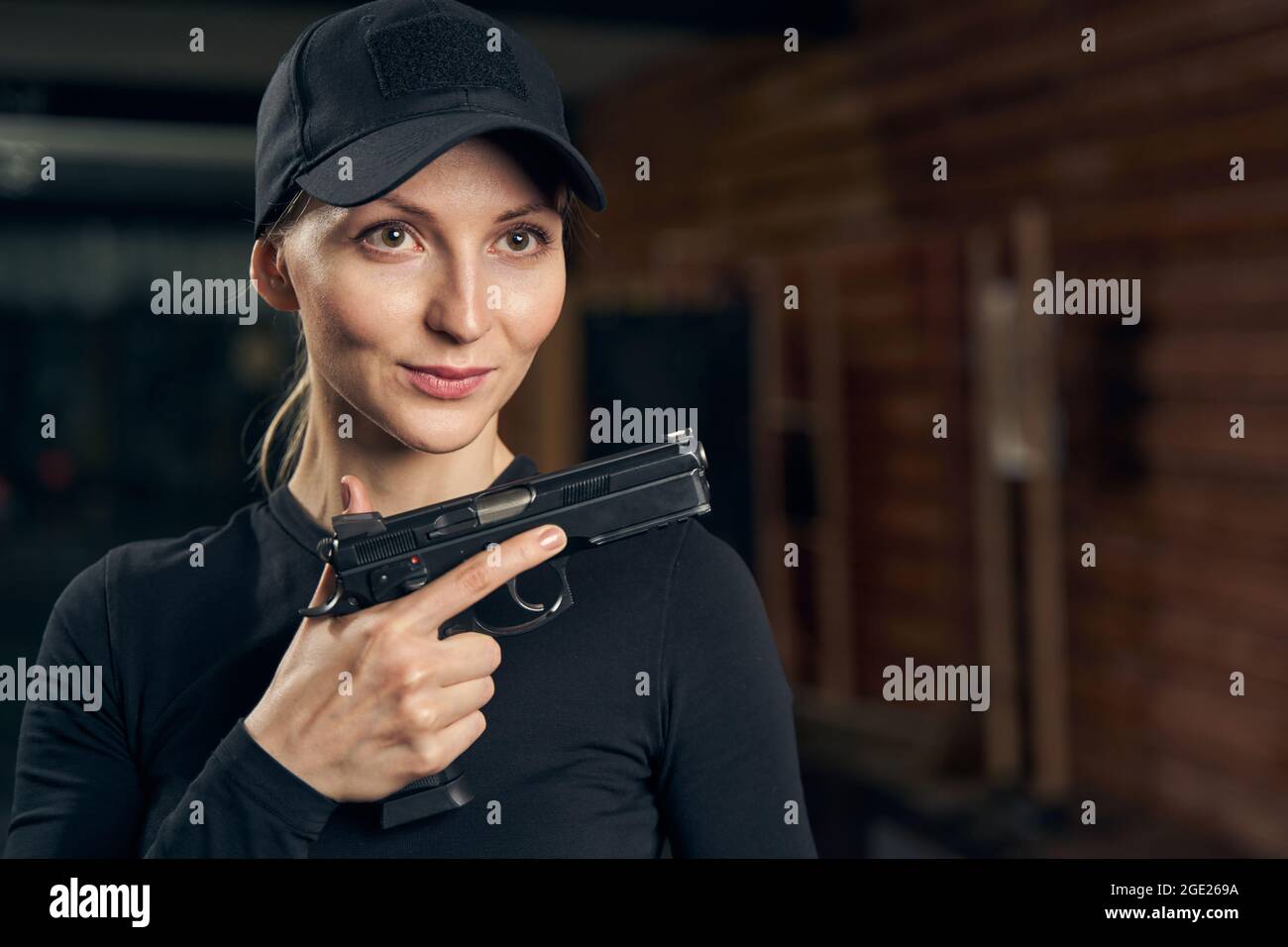 Focused female shooter mastering a one-handed handgun grip Stock Photo ...