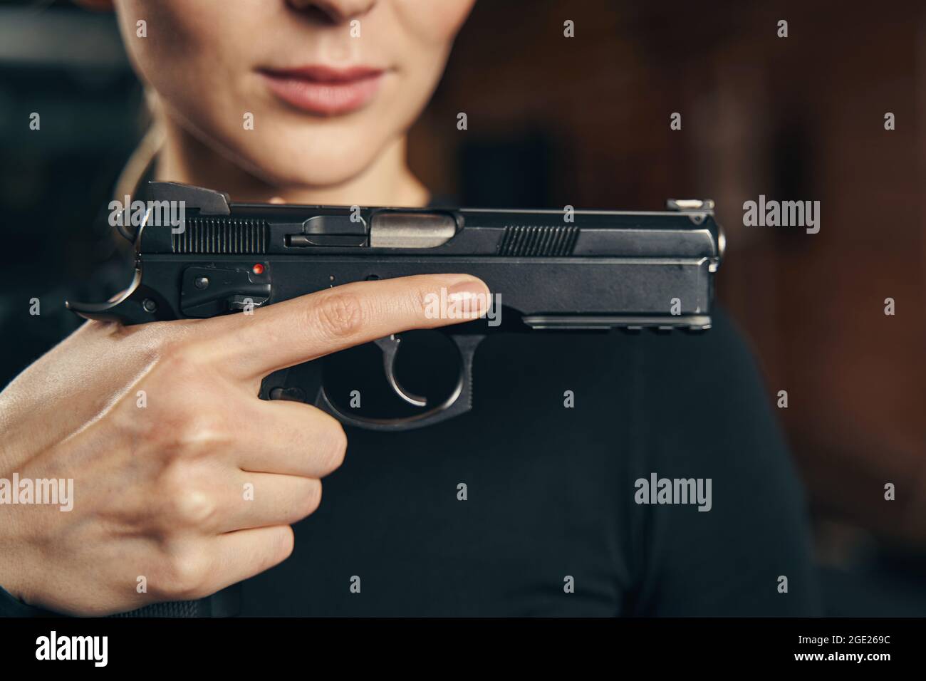 Serene female learning how to shoot using one hand Stock Photo - Alamy