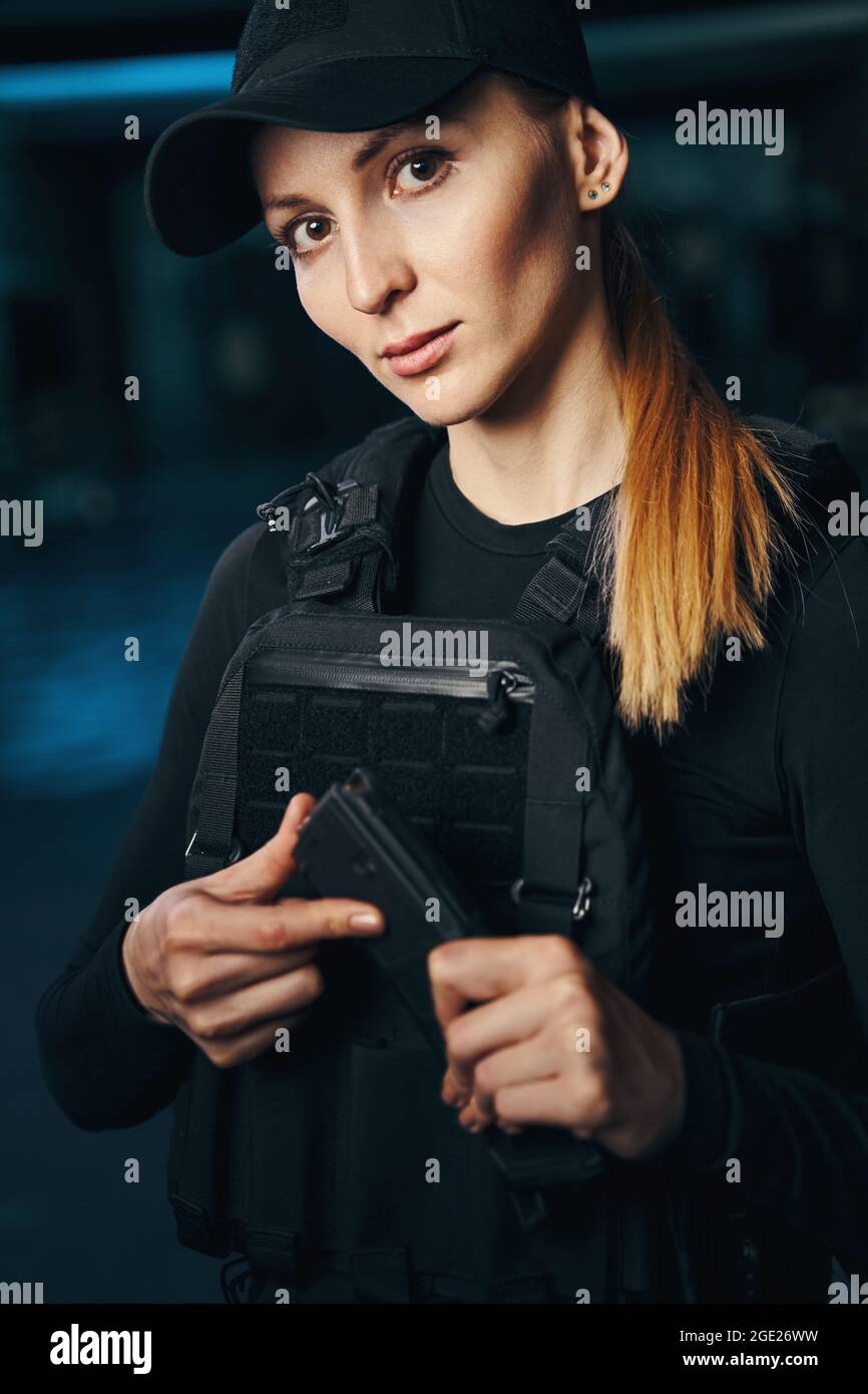 Female shooter loading her firearm at the shooting range Stock Photo ...