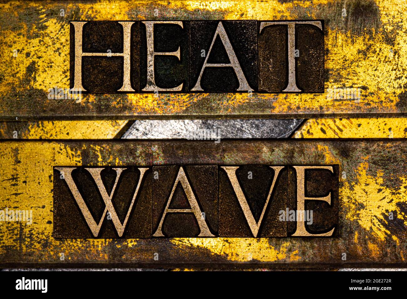 Heat Wave text on vintage grunge textured copper and gold background ...
