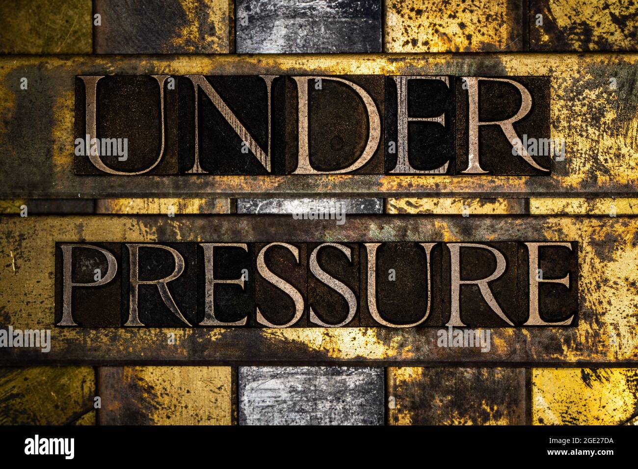 Under Pressure text message on textured grunge copper and vintage gold ...