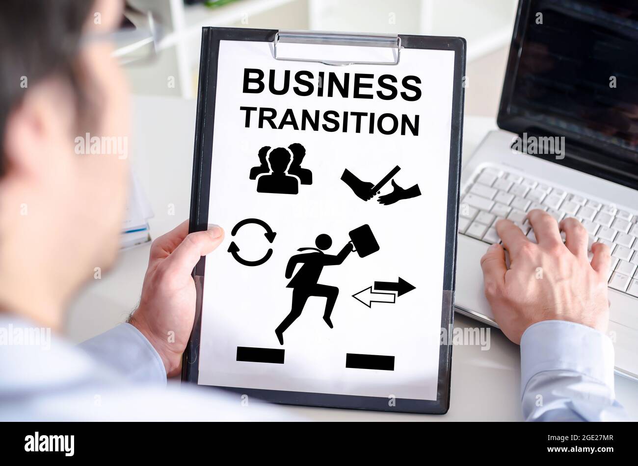 Man holding a clipboard with business transition concept Stock Photo ...