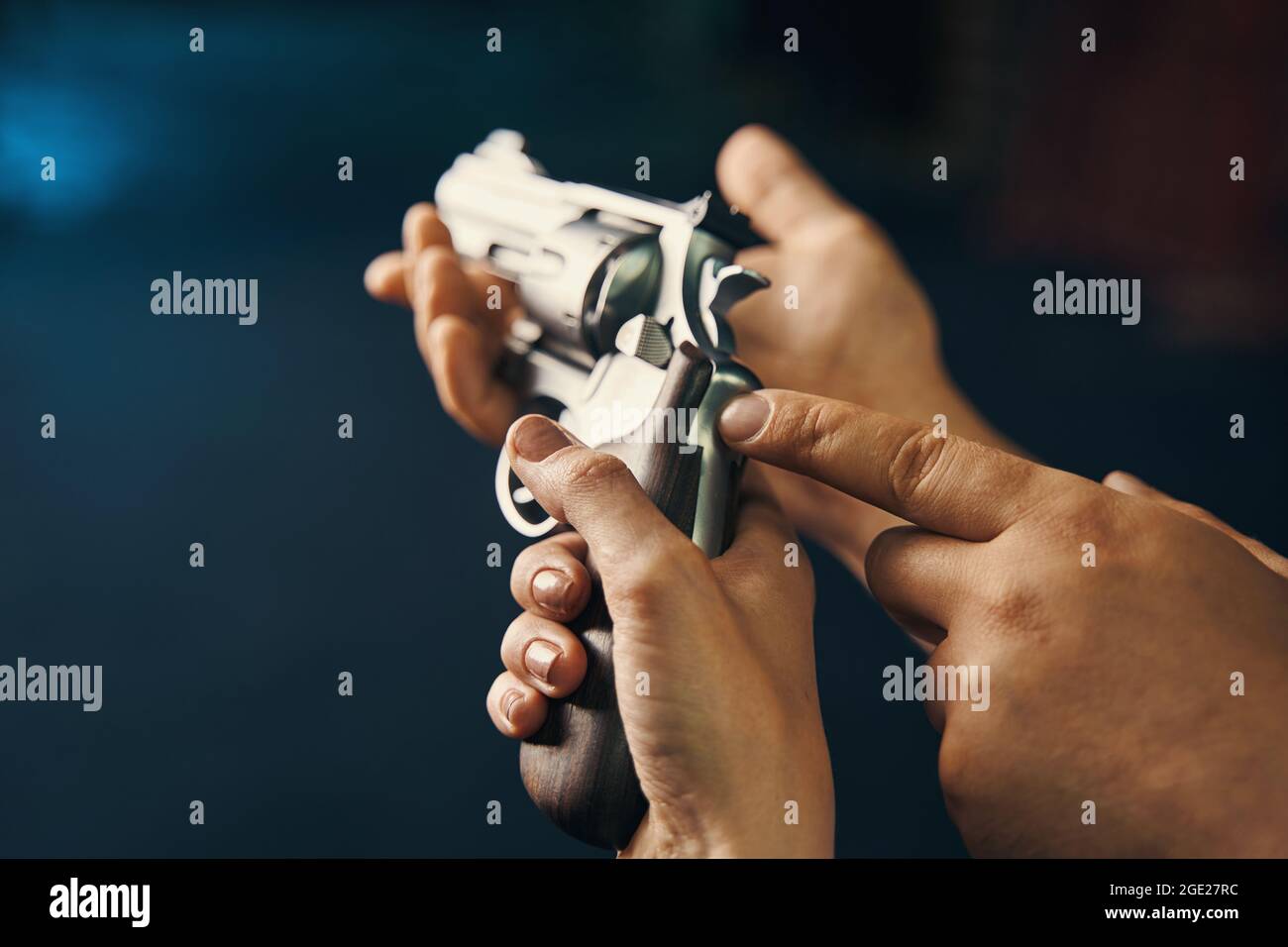 Female learning to handle a gun assisted by a certified instructor ...