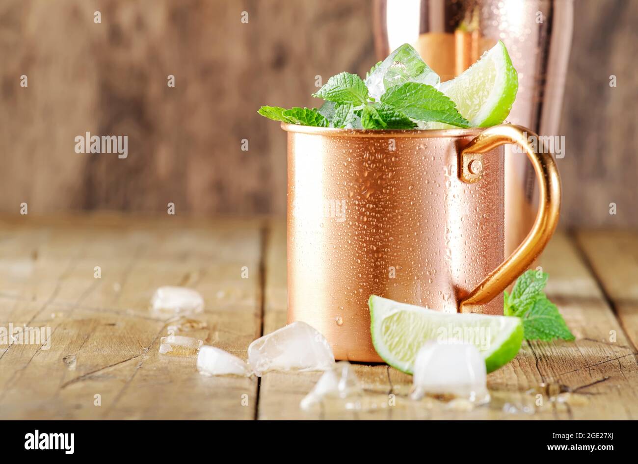 Moscow mule cocktails in copper mug with lime, ice, ginger beer, vodka ...
