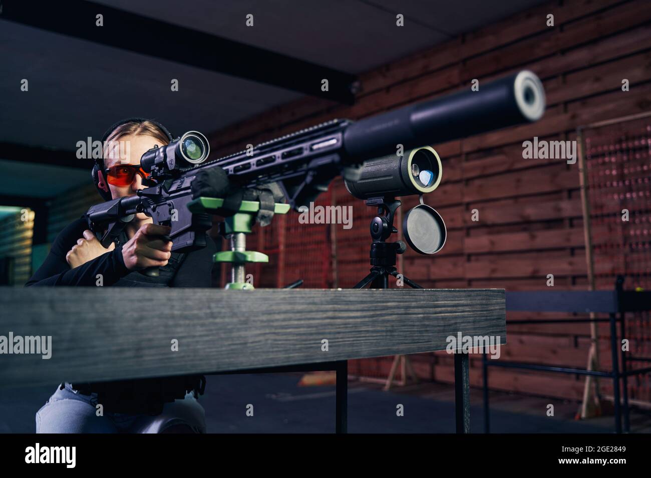 Sniper shooting a firearm with a riflescope Stock Photo - Alamy