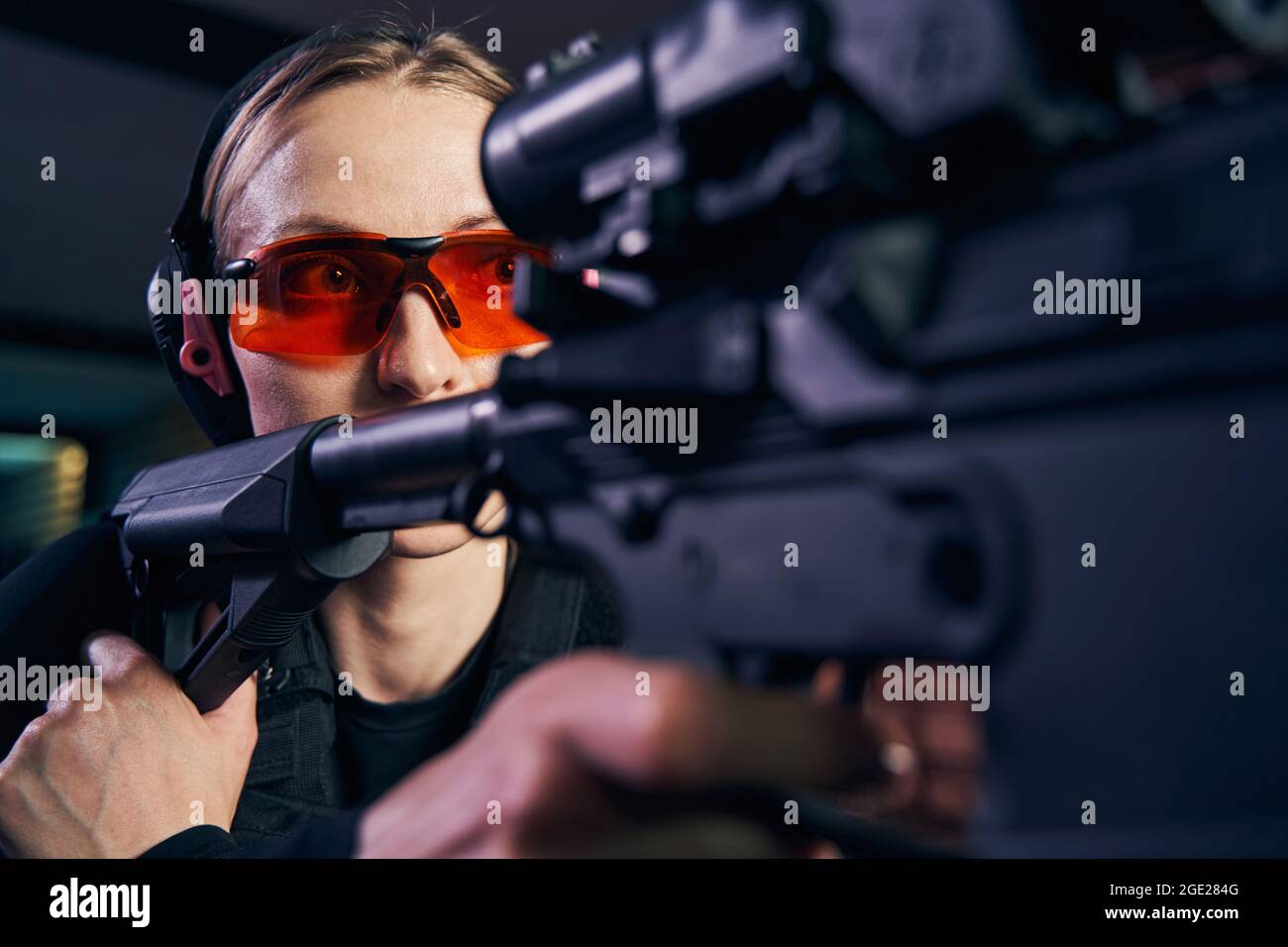 Female sniper firing a machine gun with a telescopic sight Stock Photo ...