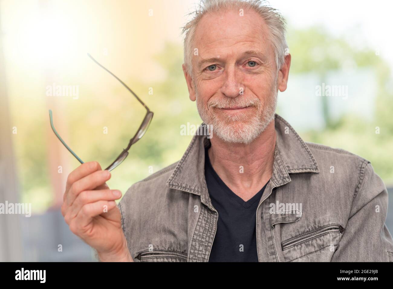 Portrait of satisfied mature man, light effect Stock Photo - Alamy