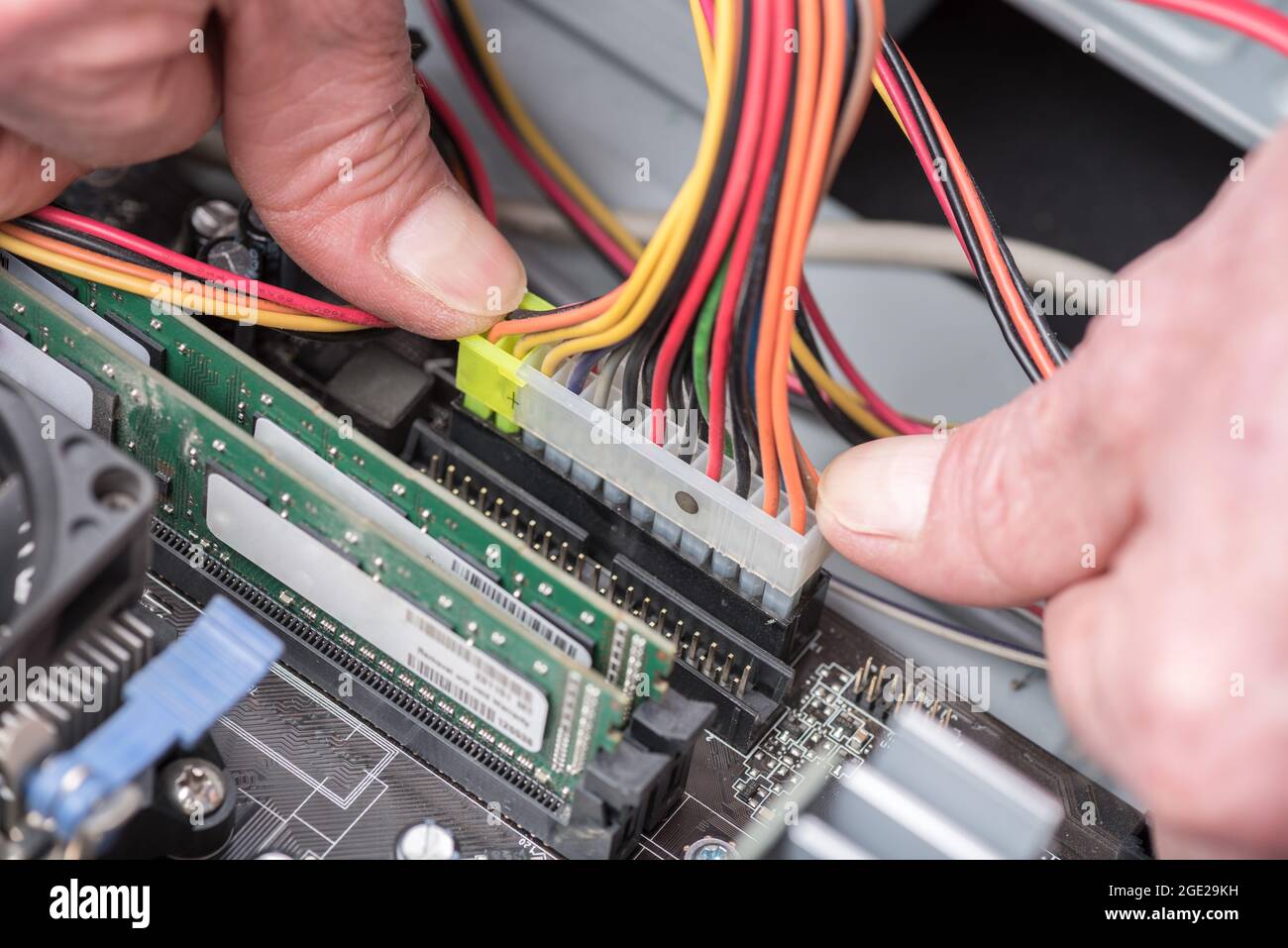 Computer technician connecting a power cable Stock Photo - Alamy