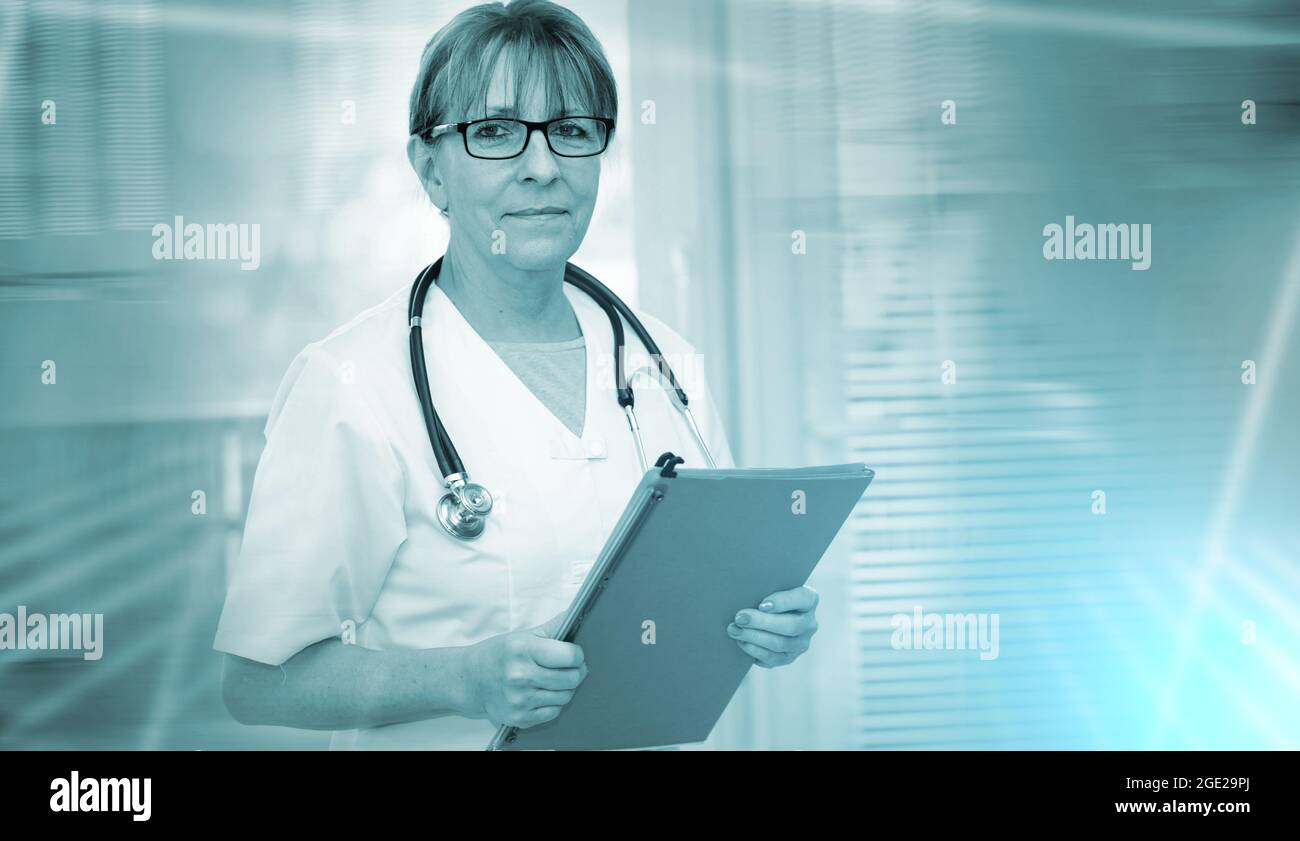 Portrait of female doctor standing and holding a folder; multiple ...