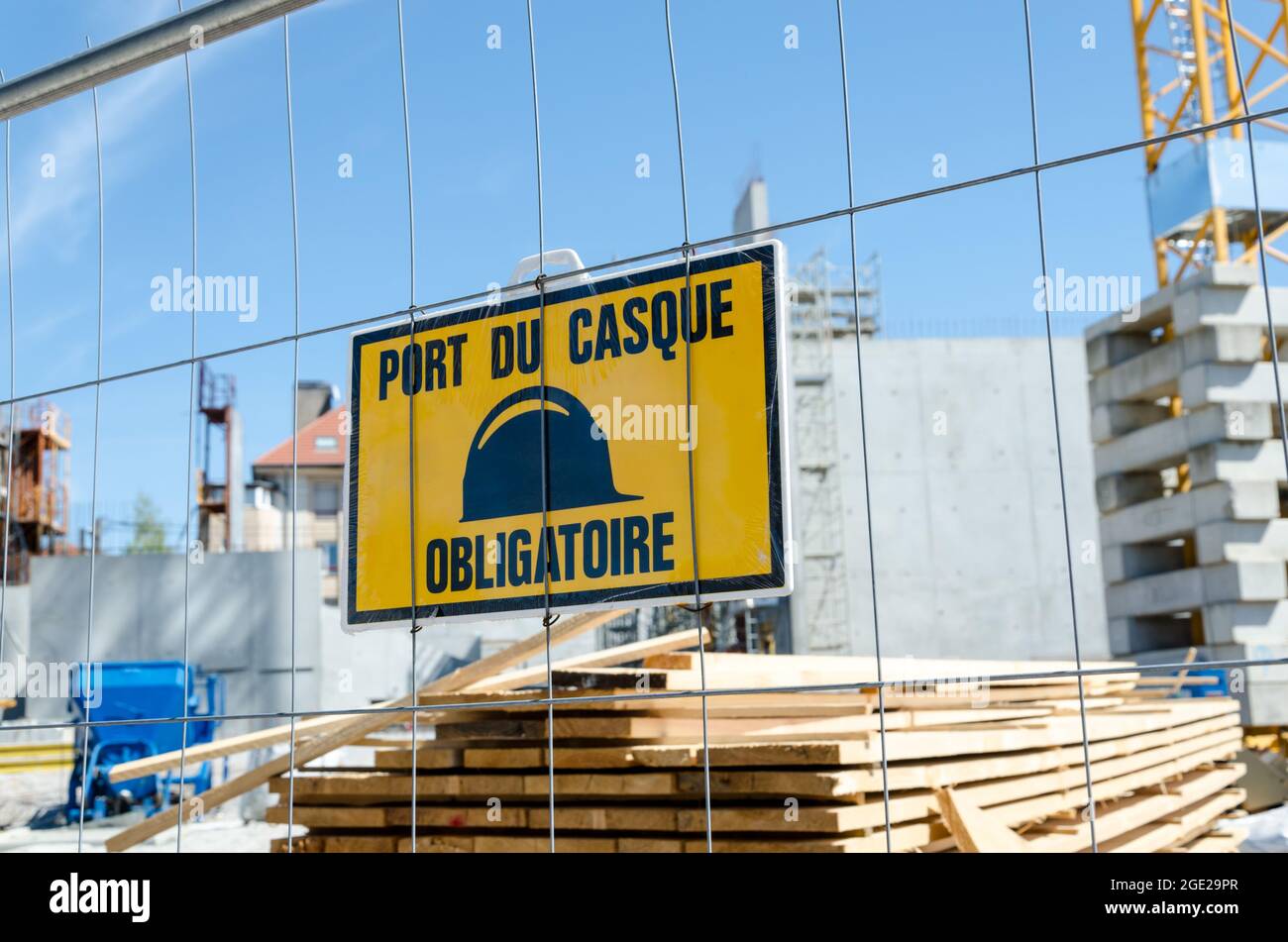 Mandatory helmet sign on construction site Stock Photo - Alamy