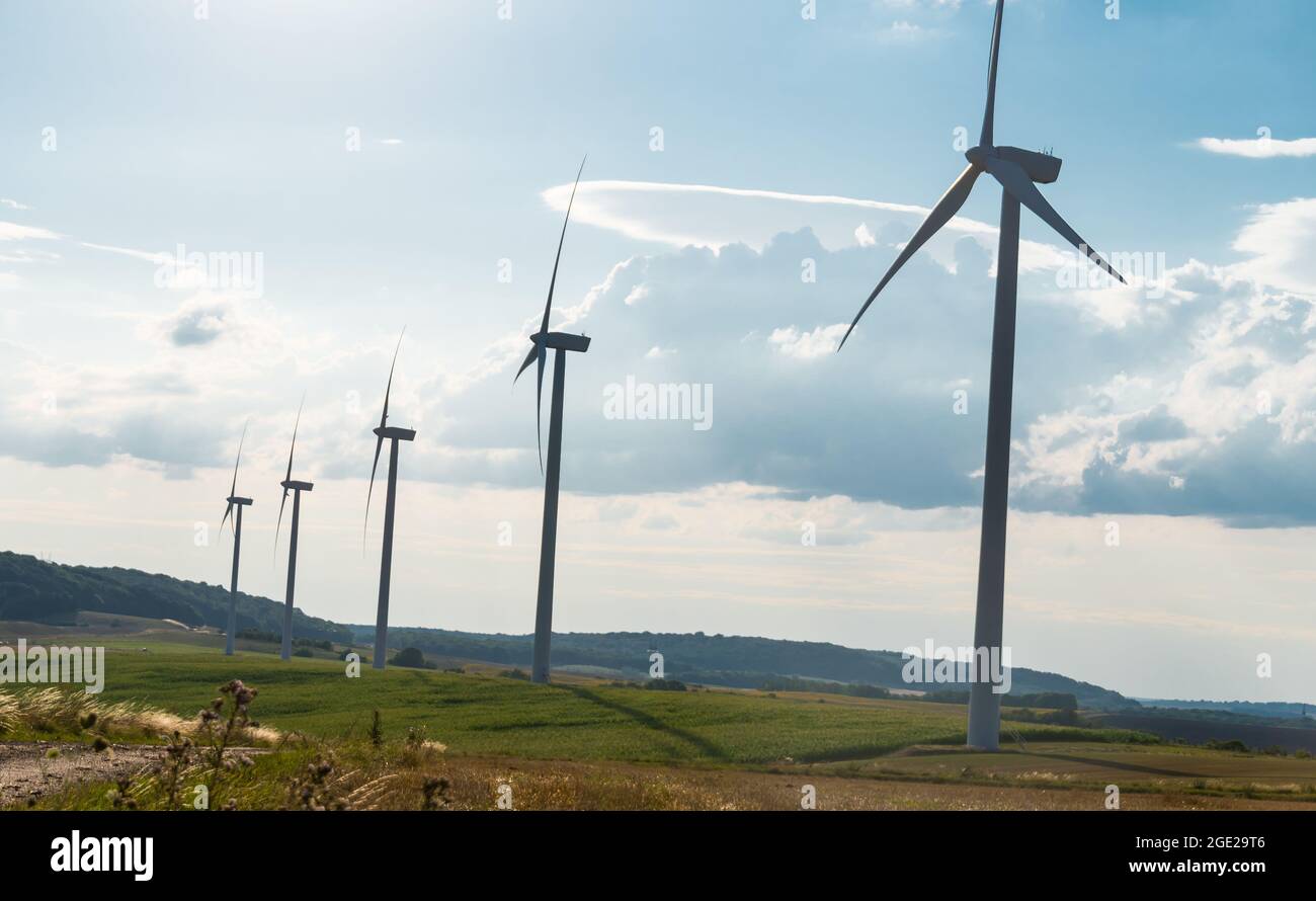 Wind turbines in a rural landscape on sky background Stock Photo - Alamy