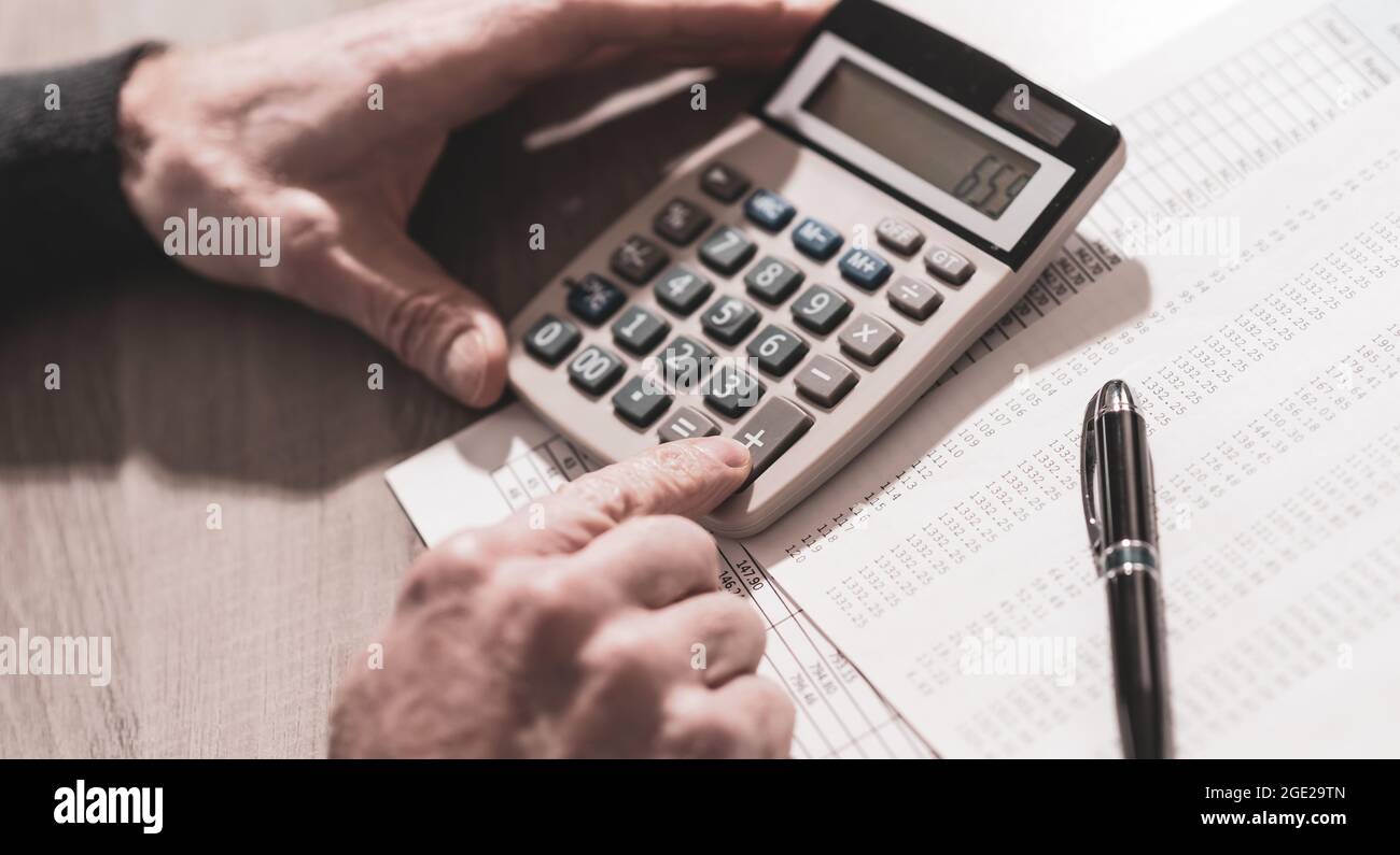 Male hand using calculator, accounting concept Stock Photo - Alamy