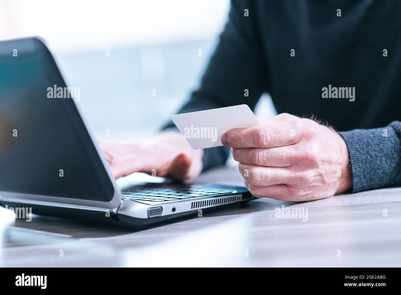 Man using his credit card for online payment Stock Photo - Alamy