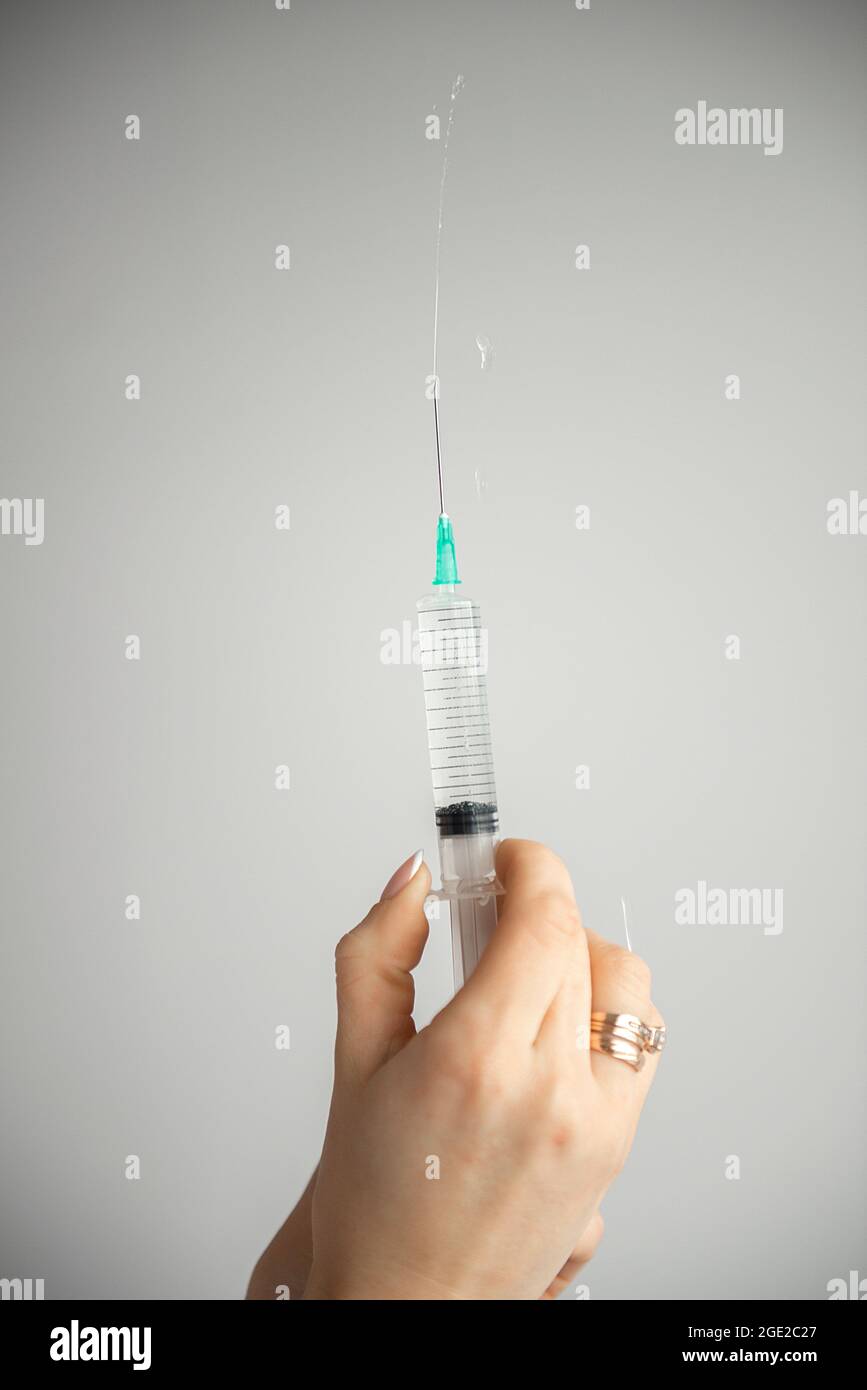 Syringe, medical injection in hand, palm or fingers. Medicine plastic ...