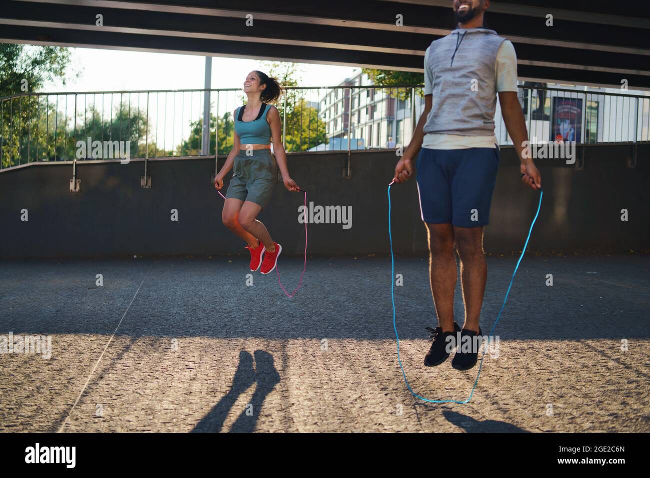 Man and woman couple friends doing workout exercise outdoors in city ...