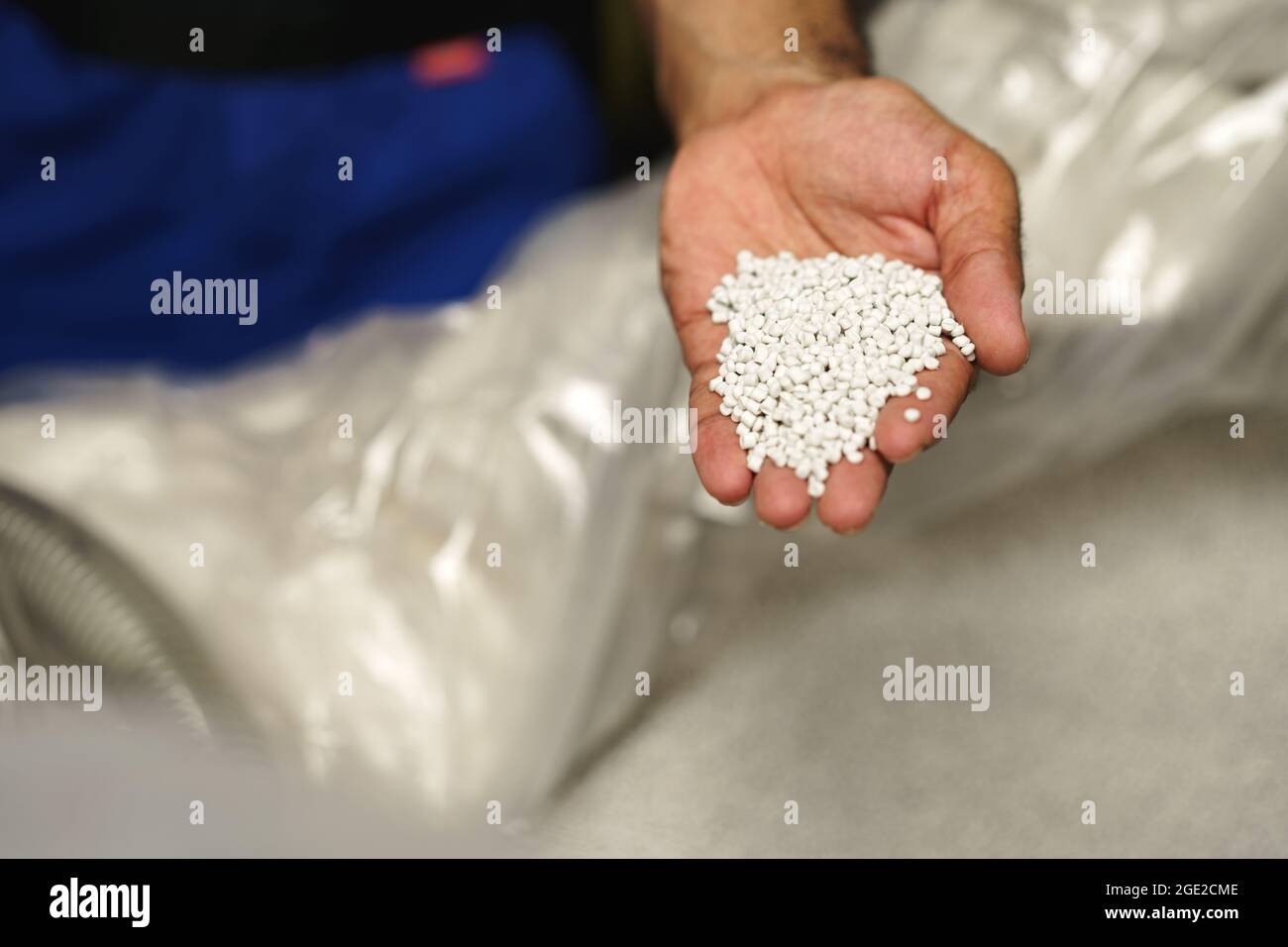 Close up of male hand holding plastic polymer granules Stock Photo - Alamy