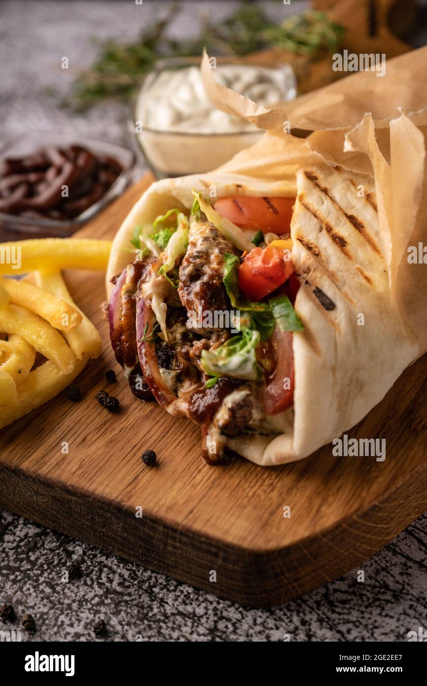doner kebab, a shawarma in a pit of fresh vegetables and meat. with ...