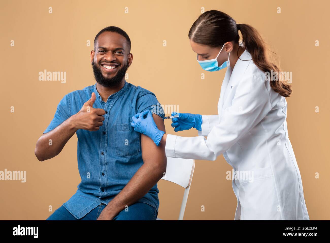 Immunization and health care. Cheerful black male patient receiving ...