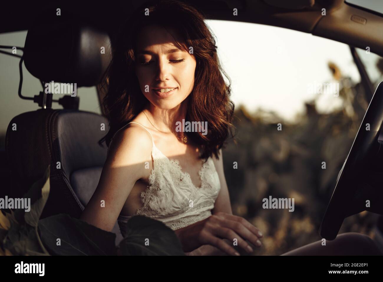 Beautiful smiling woman driving her car in the morning Stock Photo - Alamy